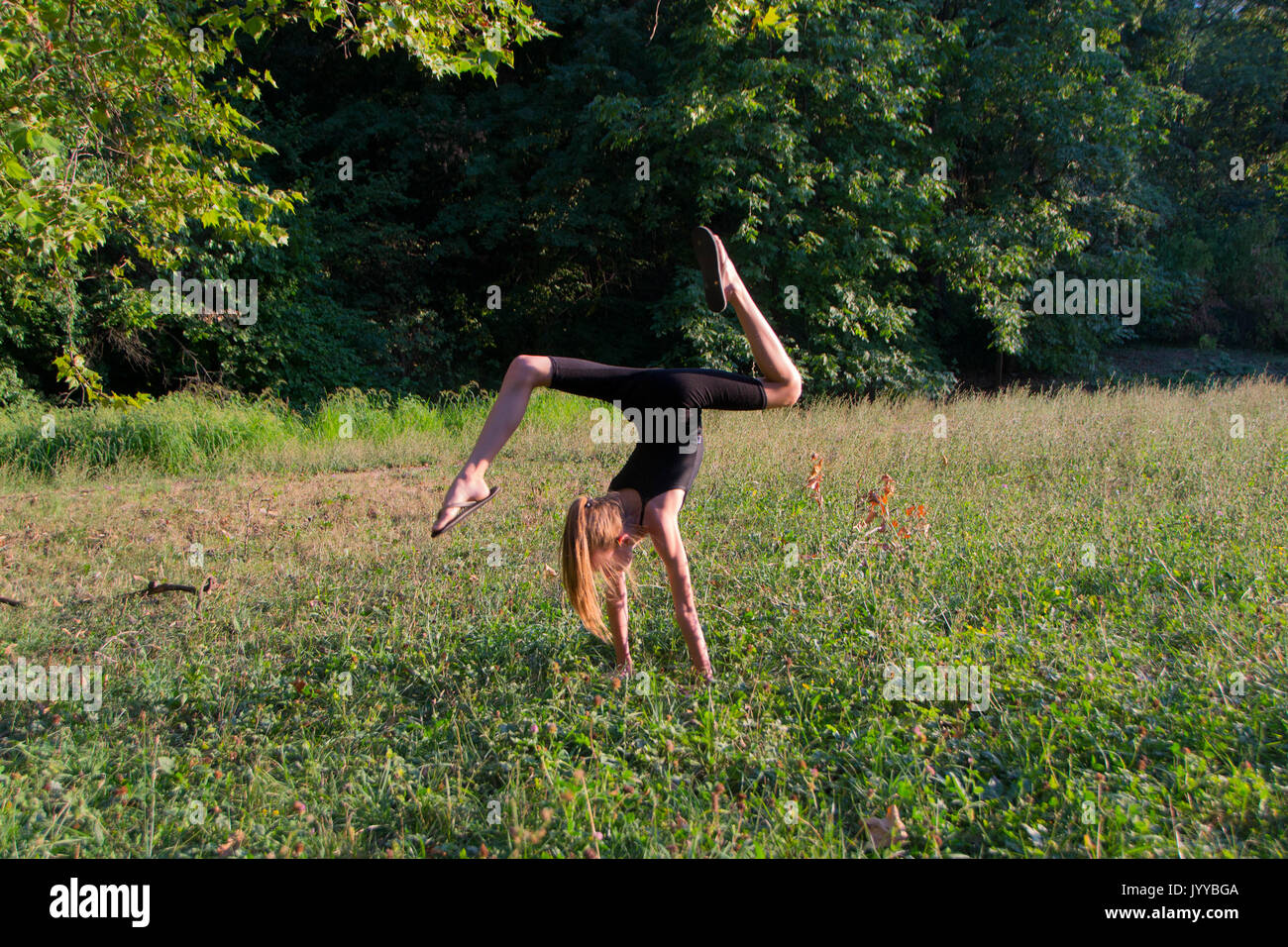 A little girl make hand stand, front walkover, back walkover, cartwheel ...