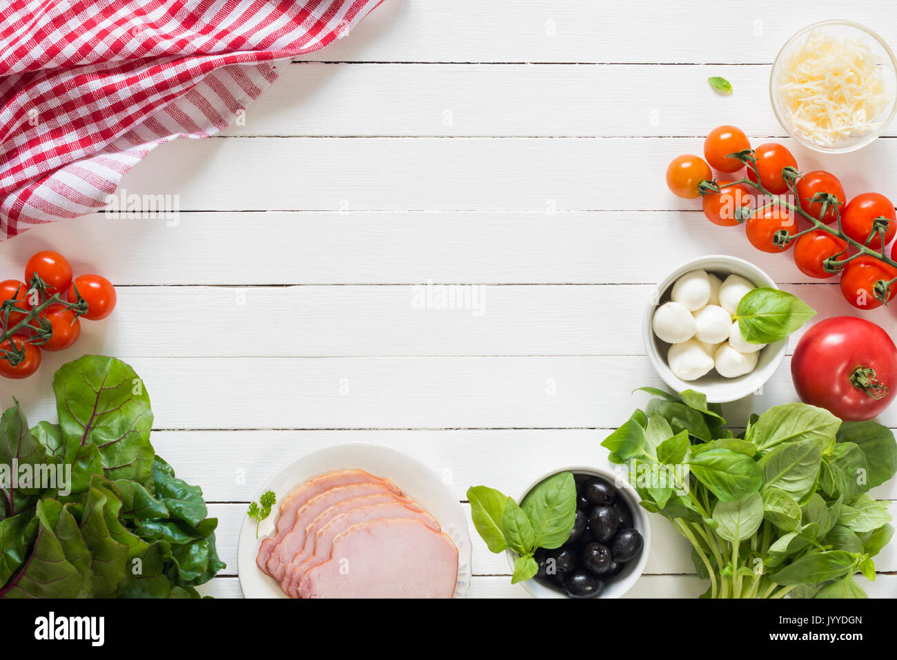 Fresh food ingredients for italian cuisine. Bunch of green basil, black ...