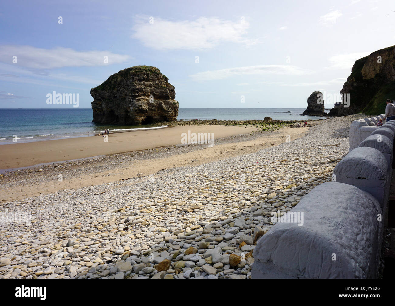 People on the beach at Marsden Rock a Rocky Formation of Limestone off ...