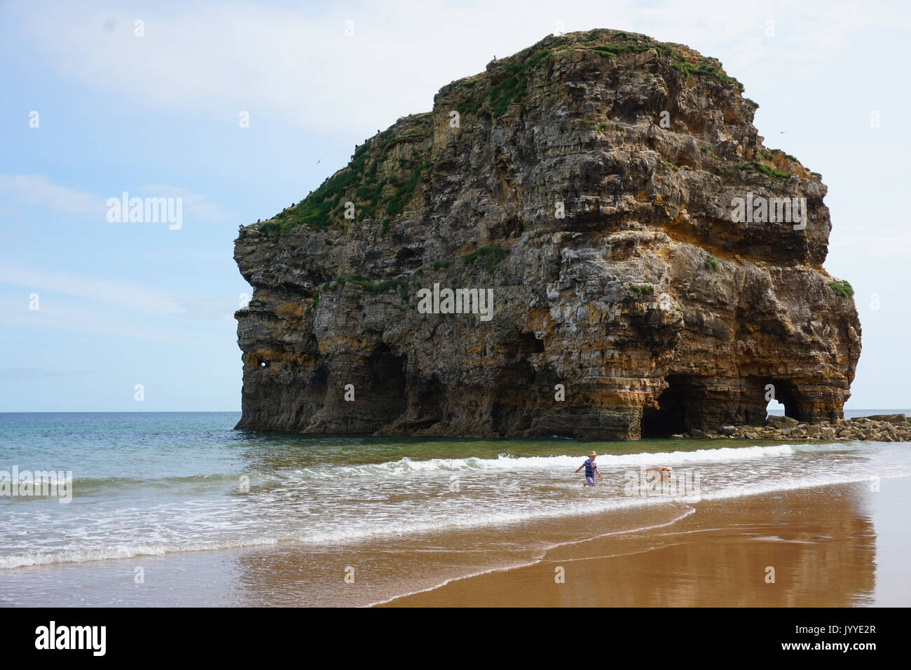 People on the beach at Marsden Rock a Rocky Formation of Limestone off ...