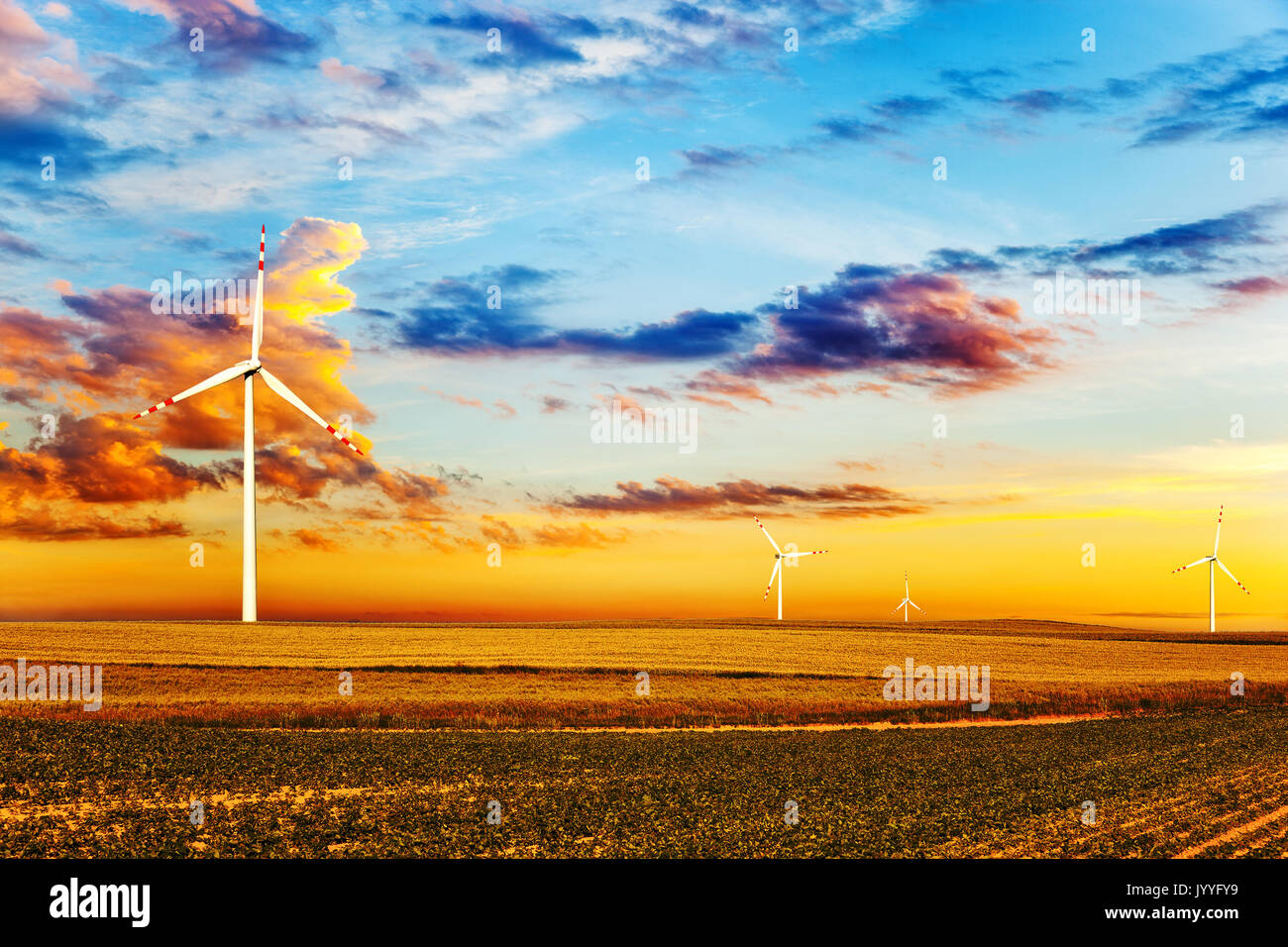 Wind turbine farm at sunset time Stock Photo - Alamy