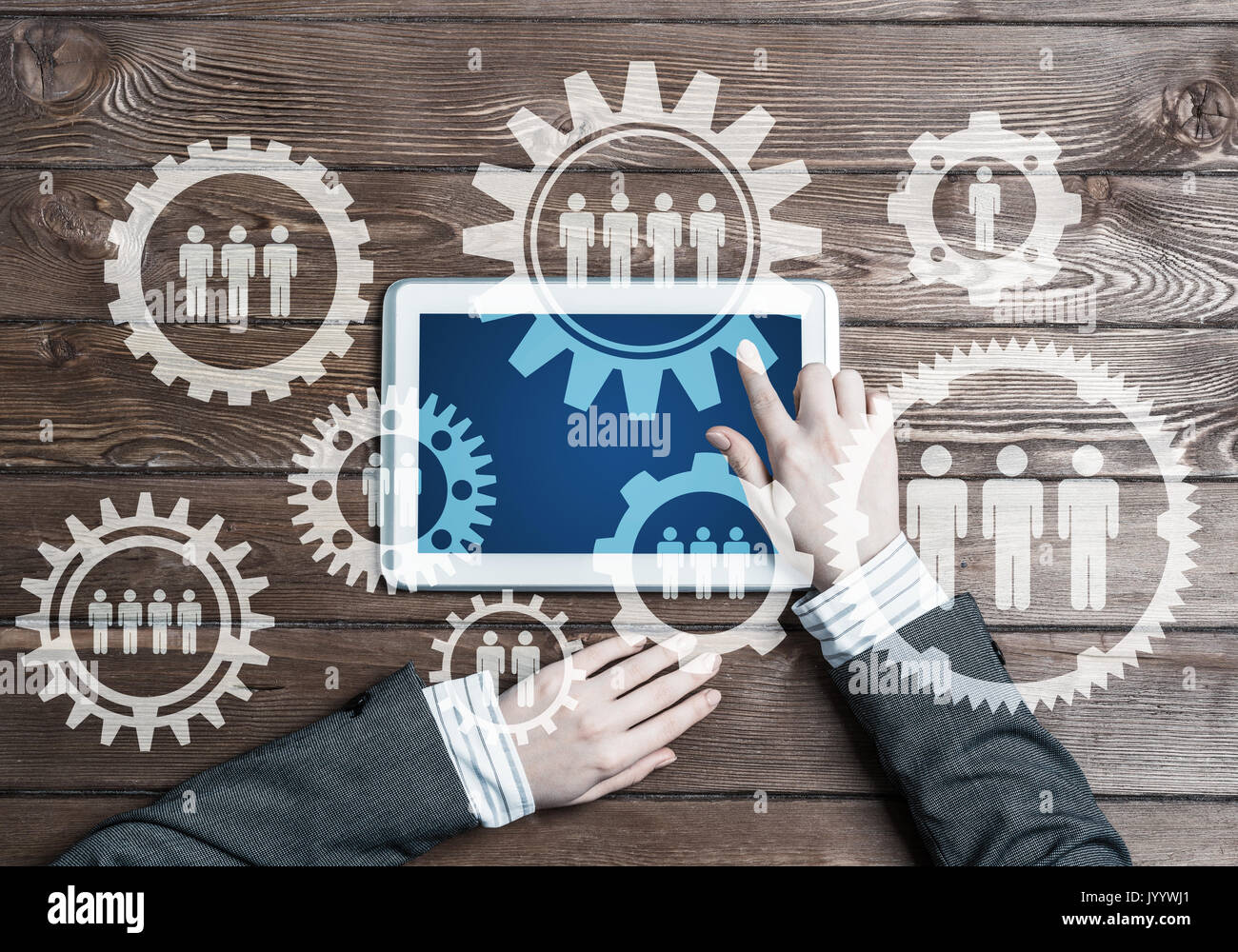 Concept of teamworking and connection with gears mechanism and tablet ...