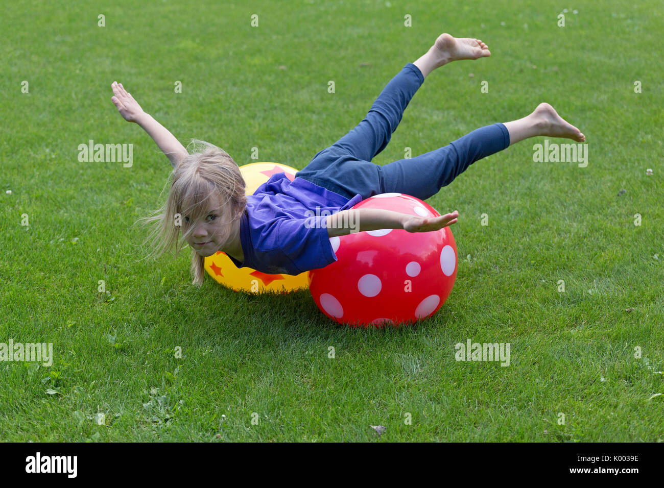 little girl doing tricks with balls Stock Photo - Alamy