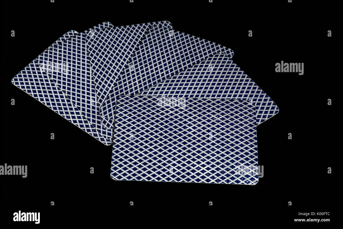 Spread playing cards deck, on a black reflective background, with ...