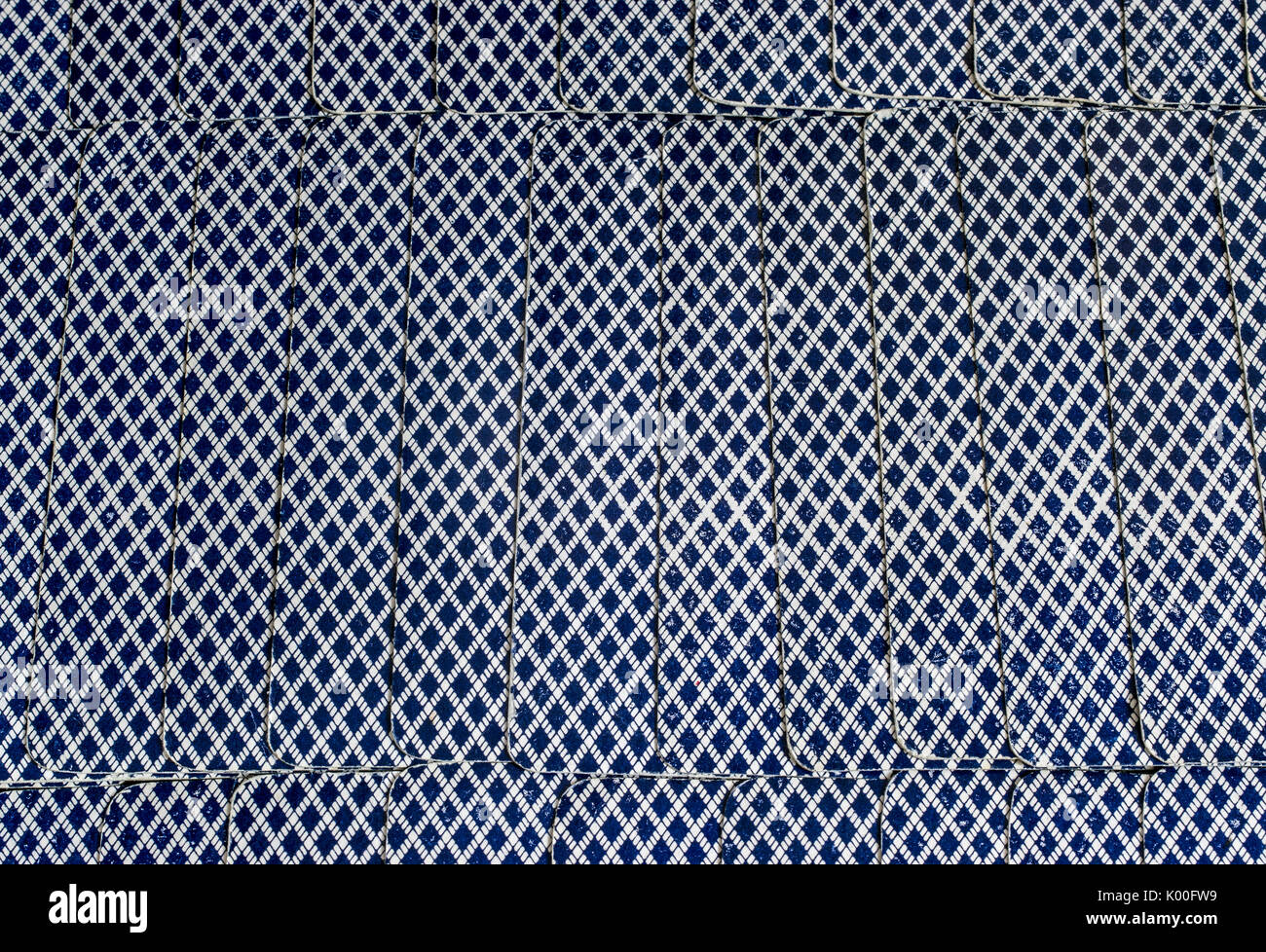 Spread playing cards deck, on a black reflective background, with ...