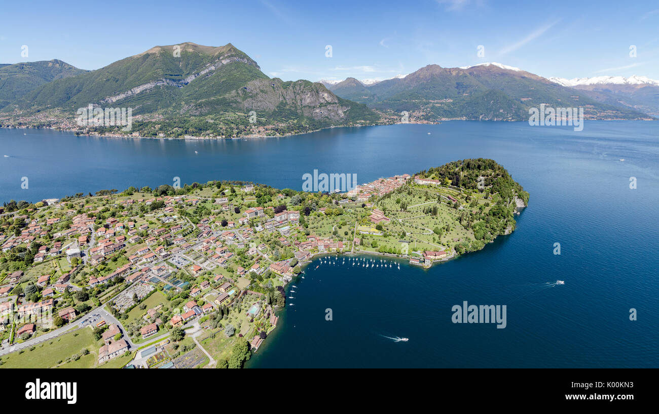 Aerial view of the village of Bellagio frames by the blue Lake Como and snowy peaks in ...
