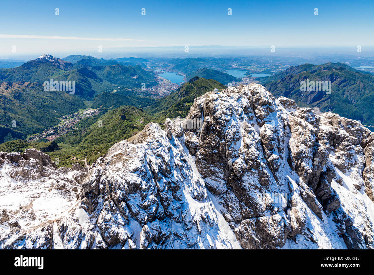 Aerial view of the snowy ridges of Grignetta and Resegone with the lake ...