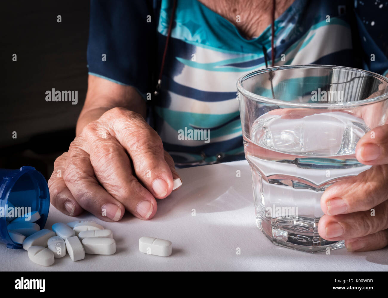 Oldster taking daily medication dose at home, Andalusia, Spain Stock ...