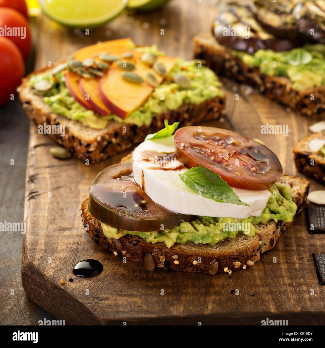 Variety of avocado toasts on a cutting board Stock Photo - Alamy