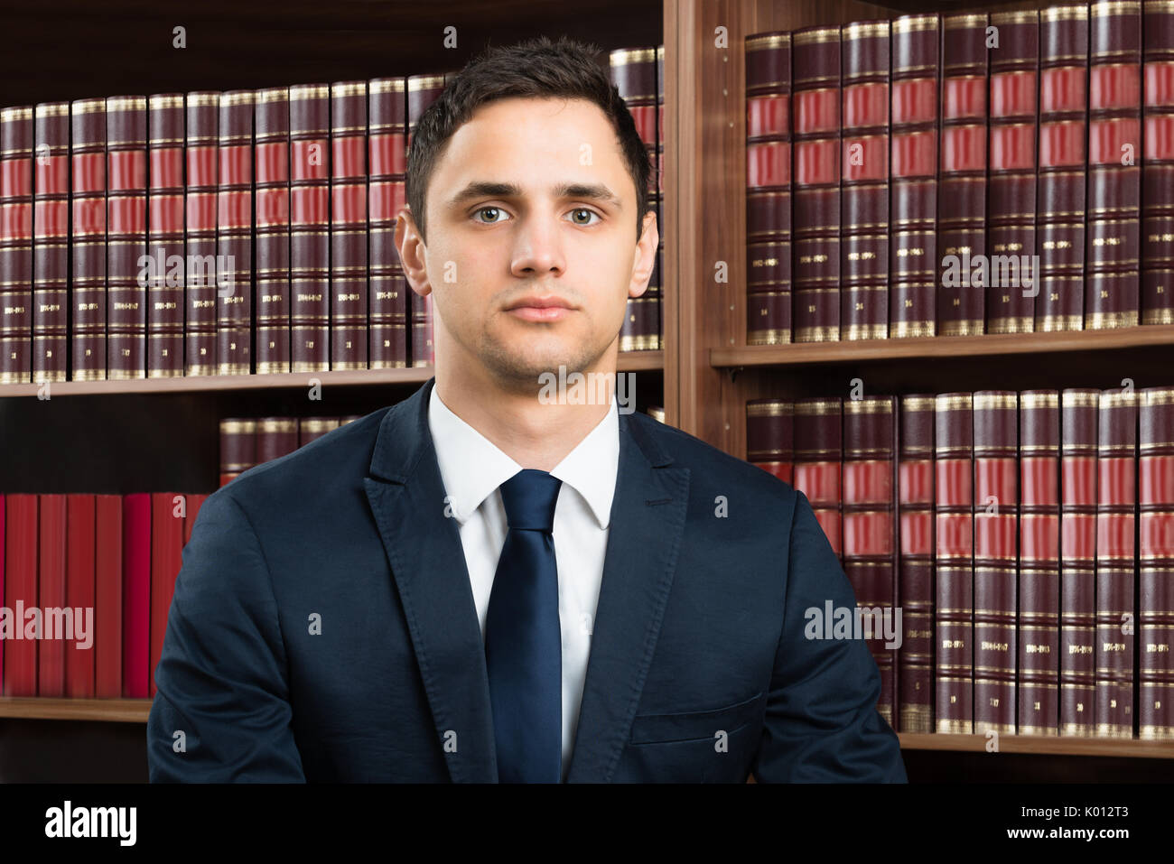 Man standing in front bookshelf hi-res stock photography and images - Alamy