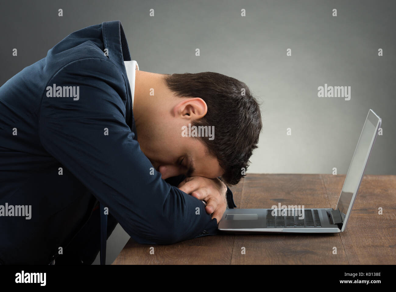 Professional man leaning against desk hi-res stock photography and ...