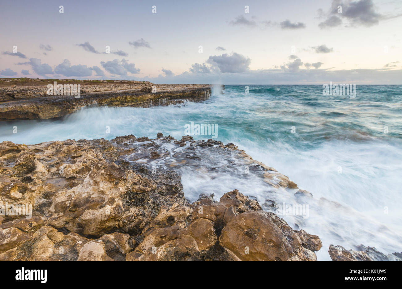 Waves of the rough sea crashing on the cliffs of Devil's Bridge ...