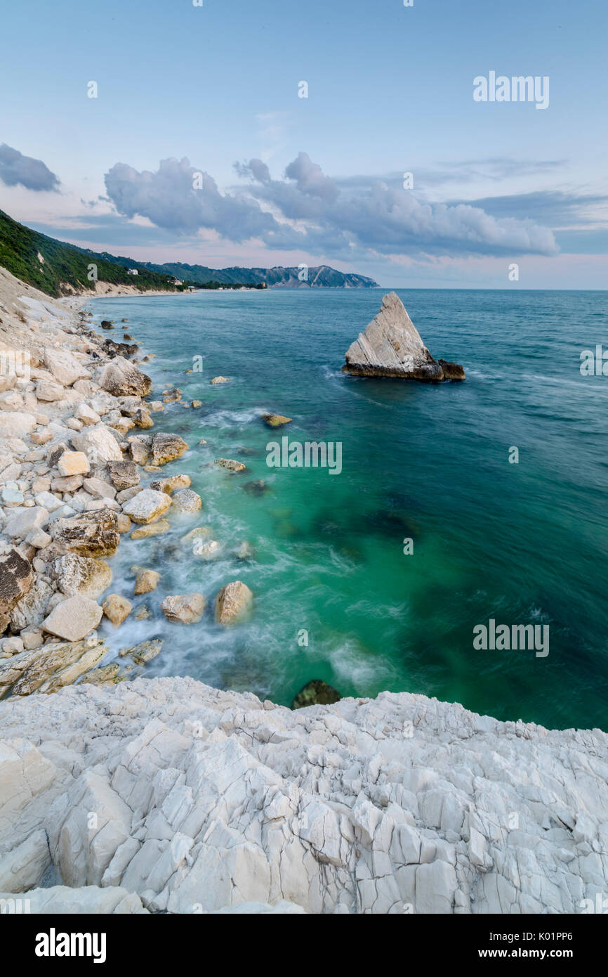 White cliffs frame the turquoise sea at sunrise La Vela Beach Portonovo ...