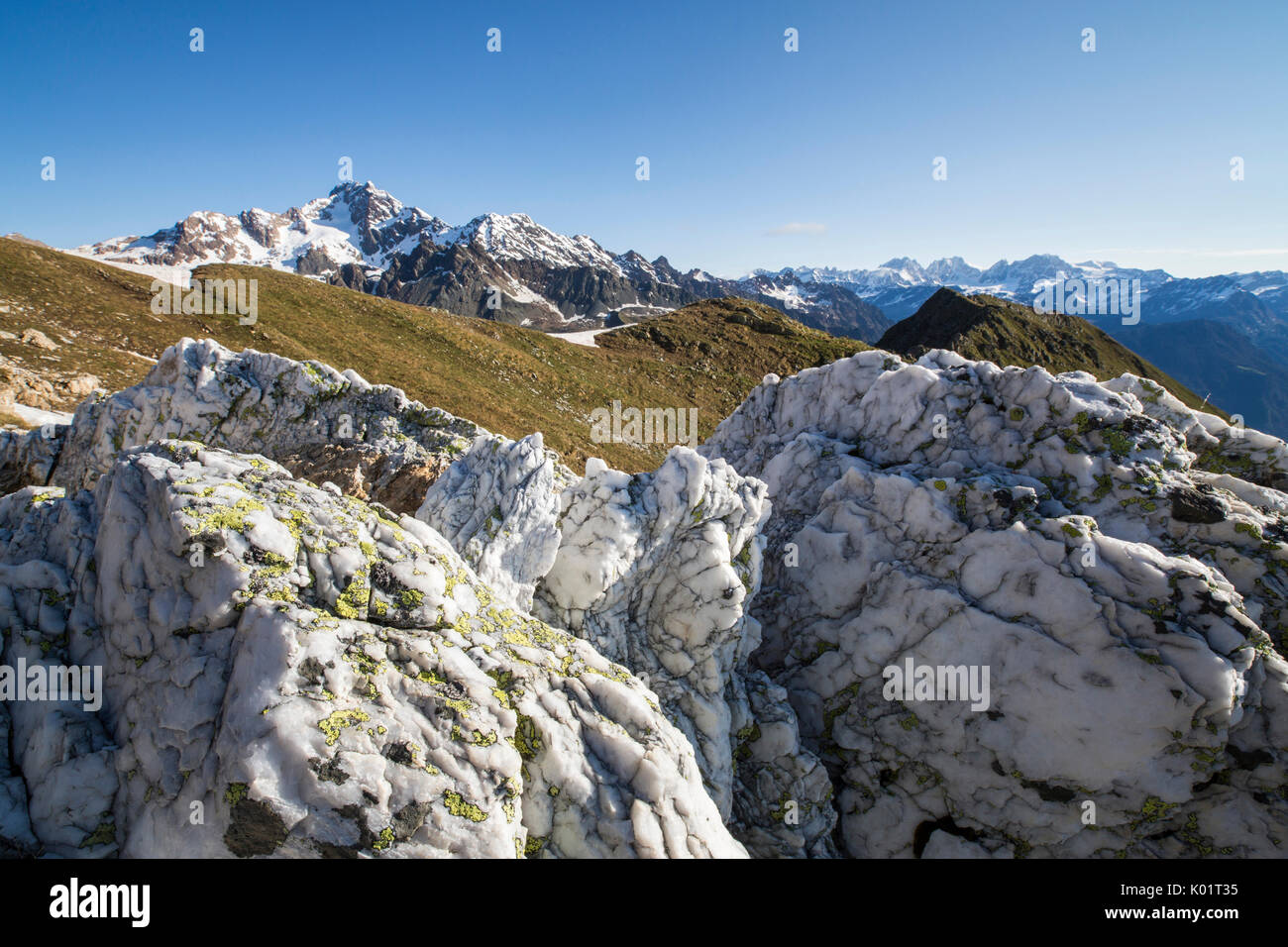 Sasso Bianco frames the snowy peak of Mount Disgrazia Malenco Valley ...