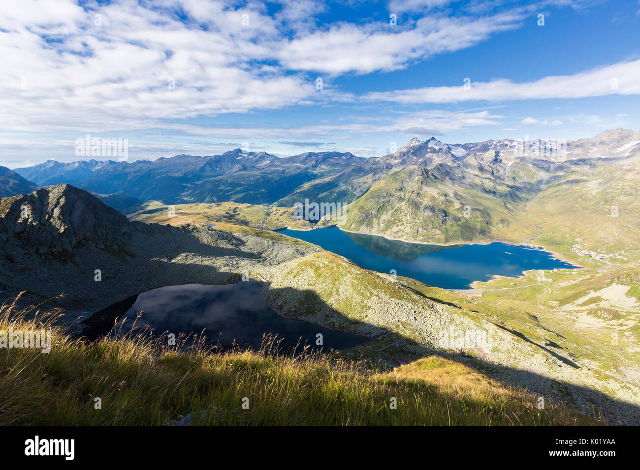 Blue sky and clouds frame the Lago Nero and Lake Montespluga in summer ...