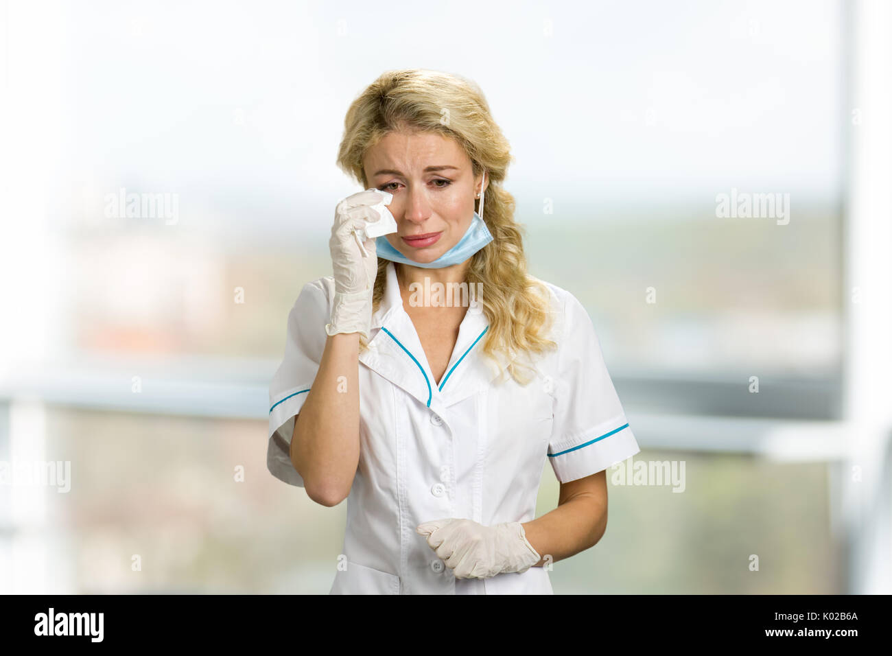 Unhappy crying young female doctor. Upset nurse or female doctor crying ...