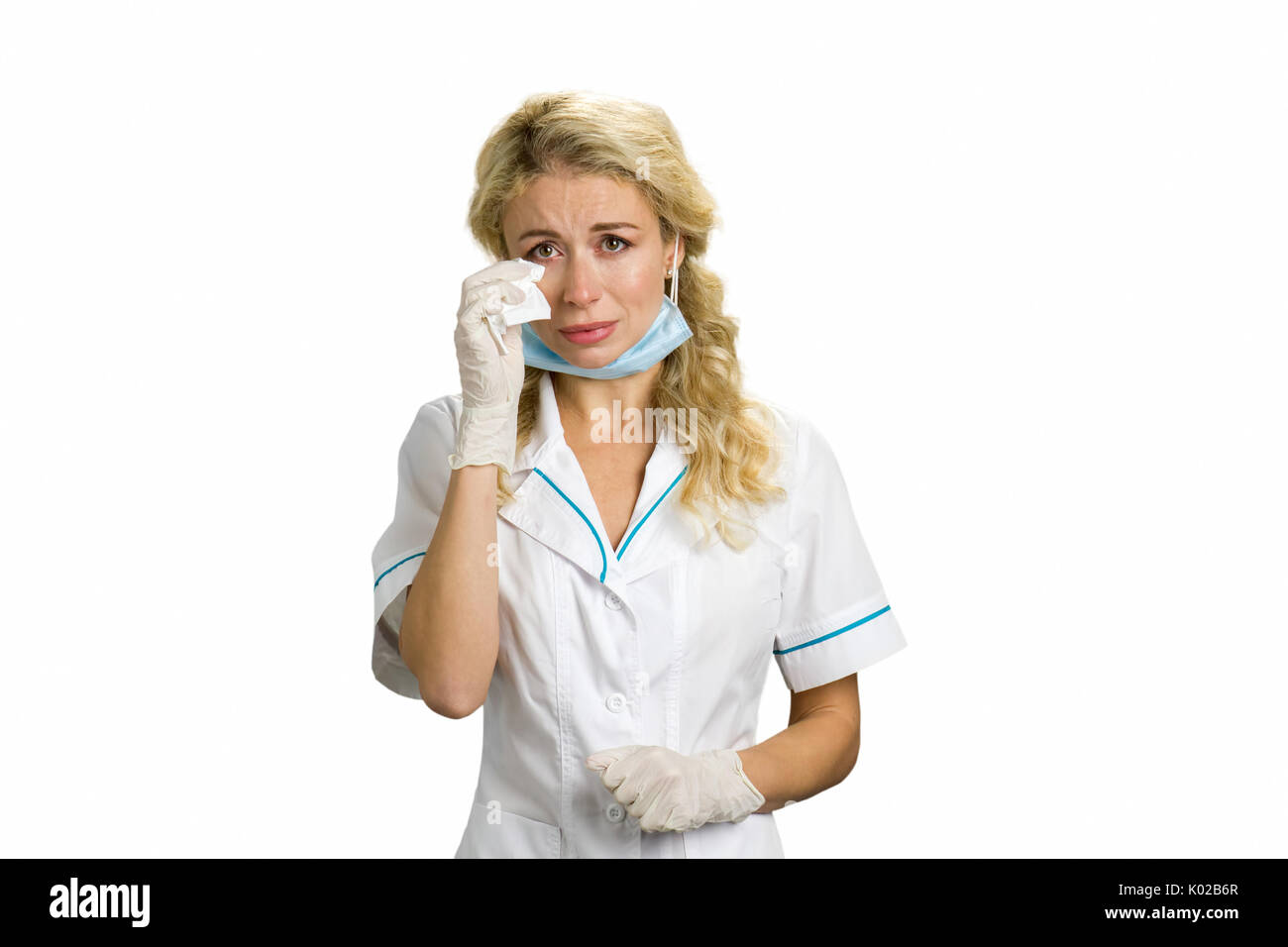 Unhappy crying young nurse. Stressed young nurse or female doctor ...