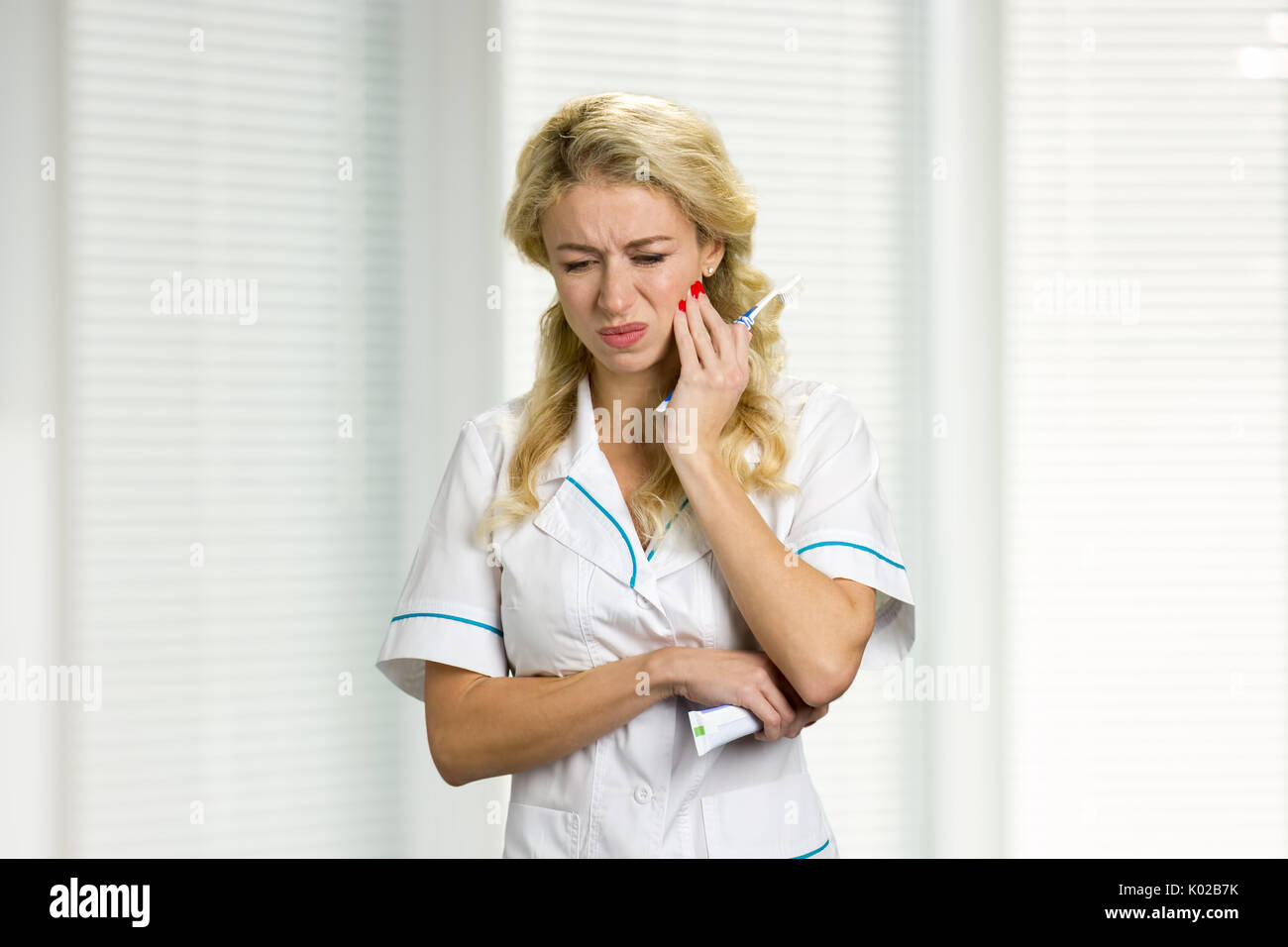 Young woman suffering from toothache. Beautiful lady feeling toothache ...