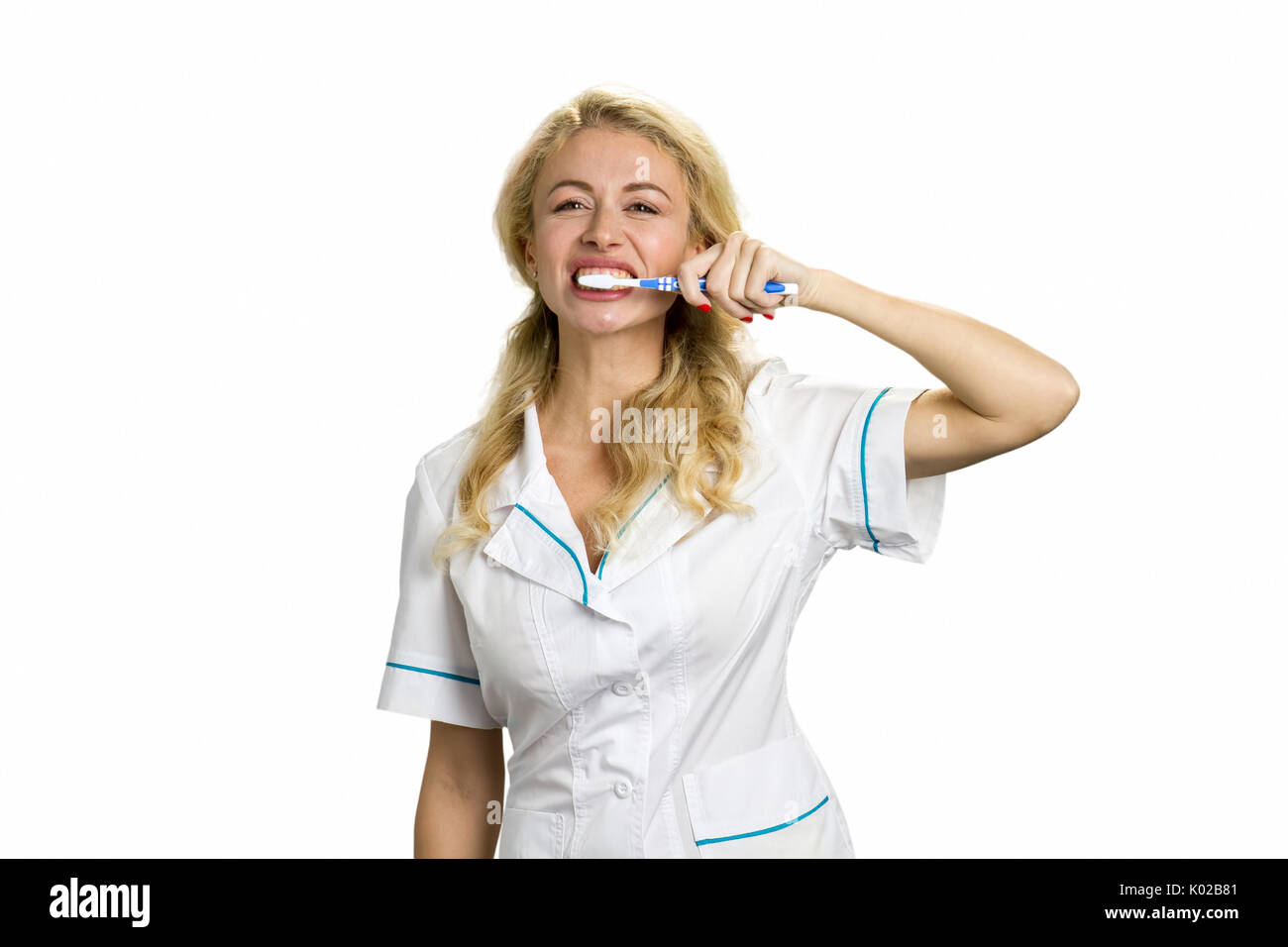 Young woman brushing teeth. Portrait of young beautiful nurse cleaning ...