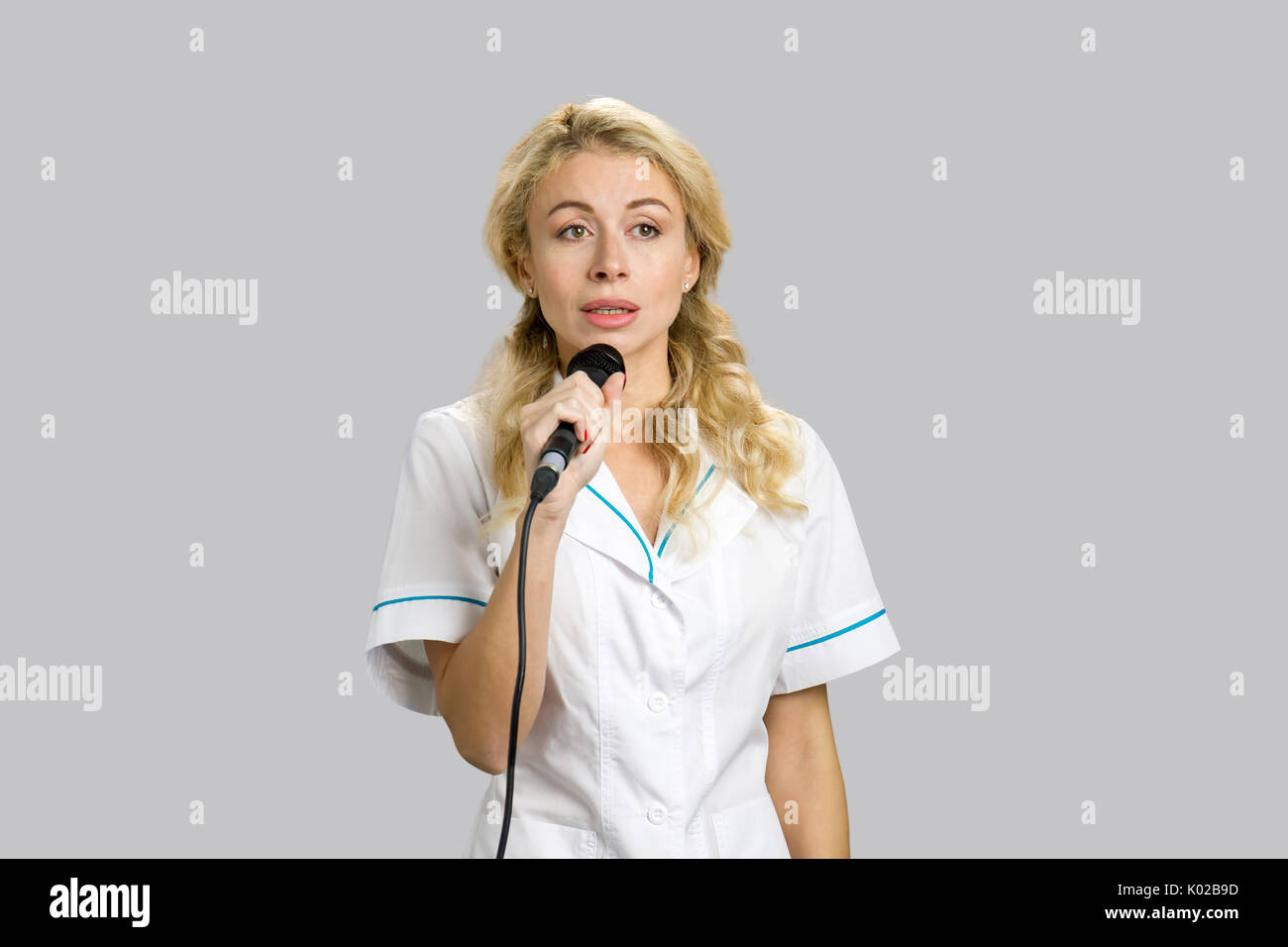Female doctor giving speech on meeting. Pretty, young medical doctor ...