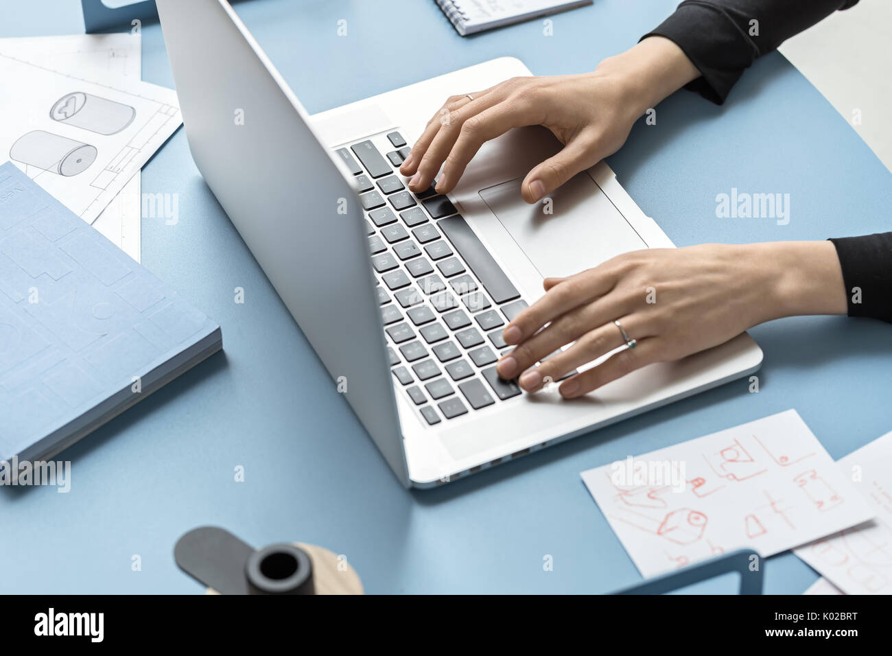 Woman using laptop in office Stock Photo - Alamy