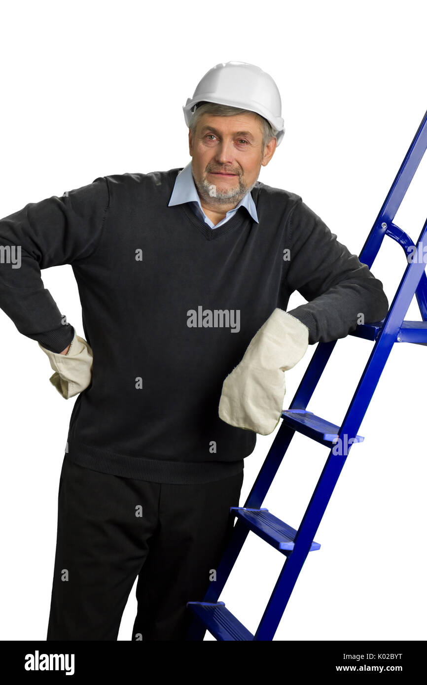 Contractor in helmet and gloves leaning on ladder. Mature construction ...