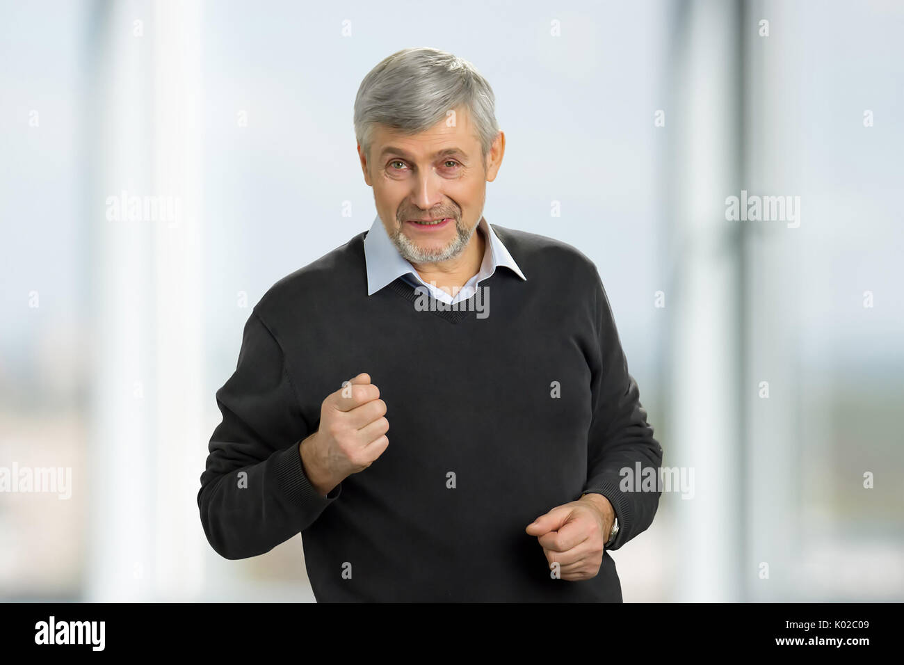 Senior man putting his fist up. A handsome mature man showing his fist ...