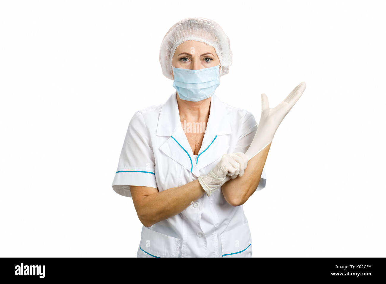 Female surgeon putting on gloves. Female doctor putting on white ...