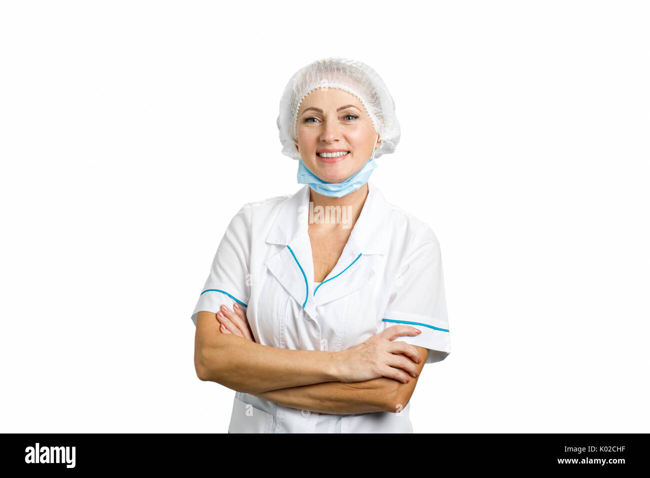 Cheerful female doctor crossed arms. Happy female surgeon standing arms ...