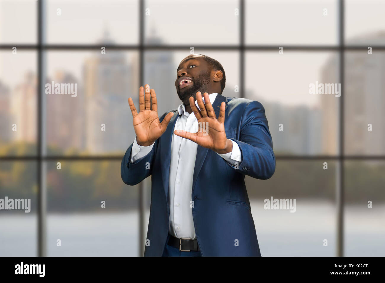 Business man put his hands forward. Black manager with emotion of fear ...