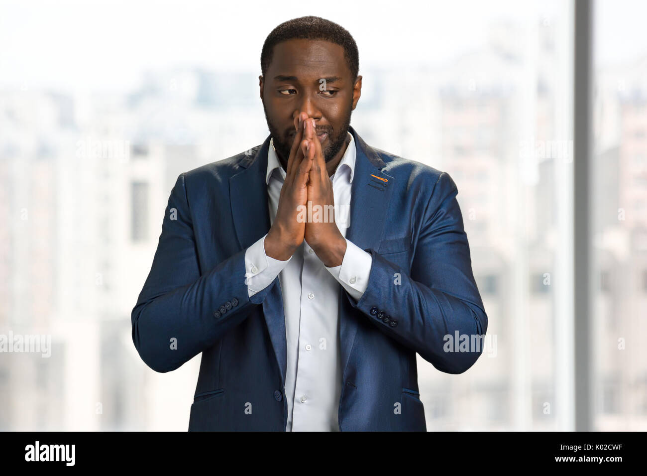 Disappointed businessman looking upset. Man in formal wear with clasped ...