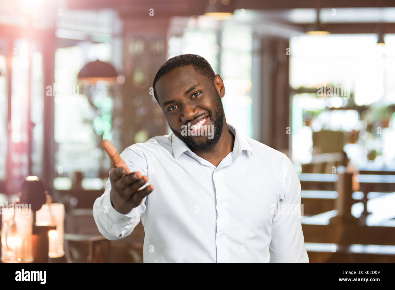 Black man in shirt pointing hand straight. Portrait of handsome man ...