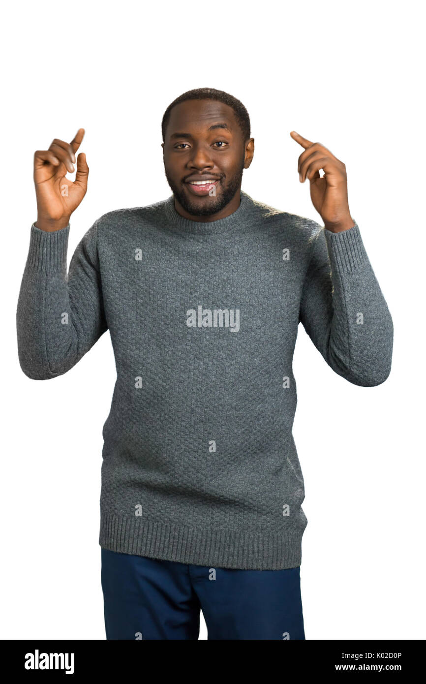 Smiling man raising hands and index finger. Positive dark skinned man ...