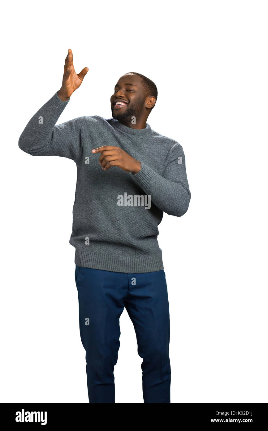 Happy black man showing direction. Man with raised right arm smile on ...