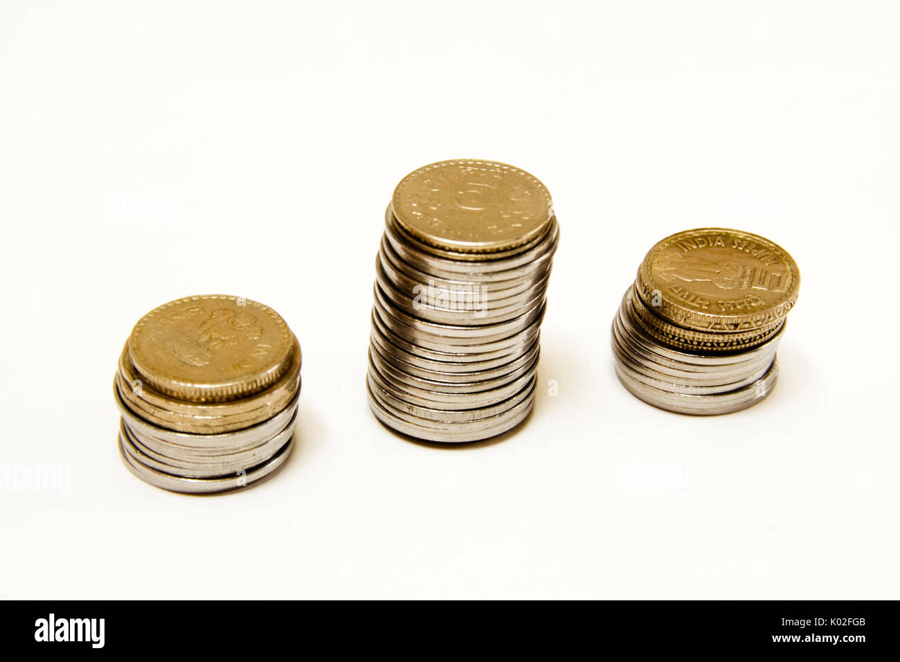 Coins arranged in three columns isolated on white background Uploaded ...