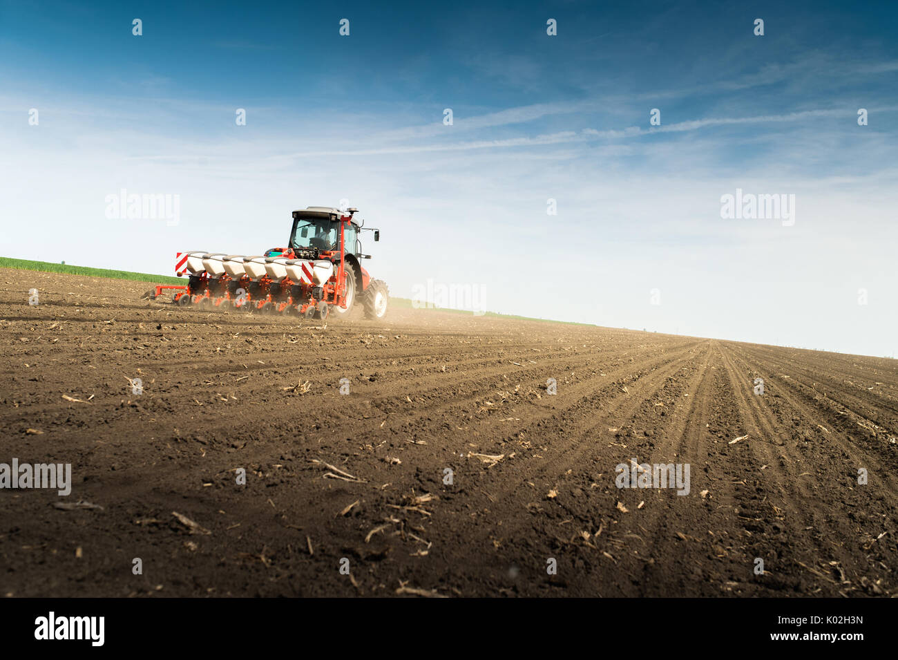 Farmer seeding crops at field Stock Photo - Alamy