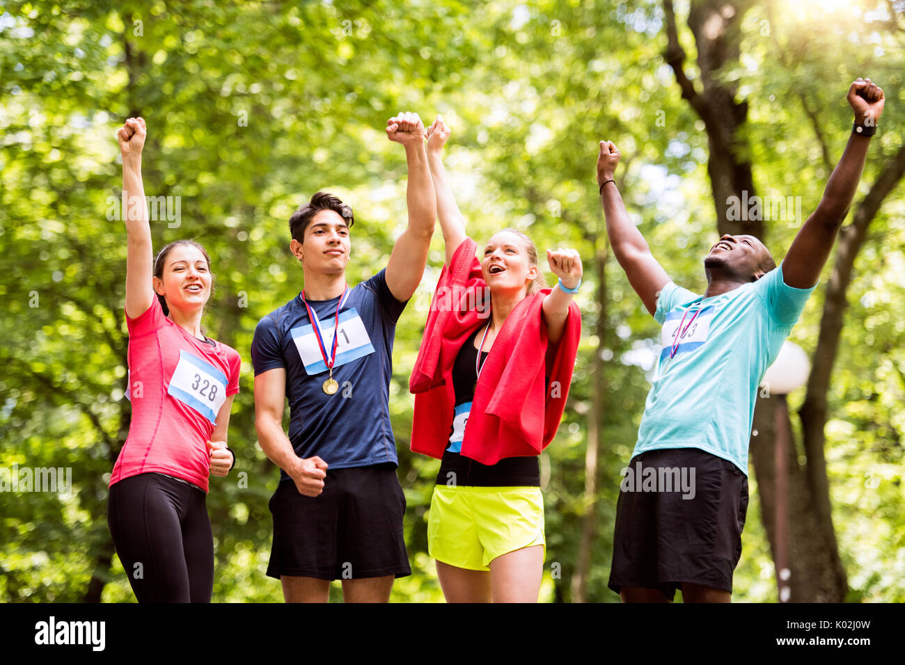 Group of young fit friends happy after finishing race Stock Photo - Alamy