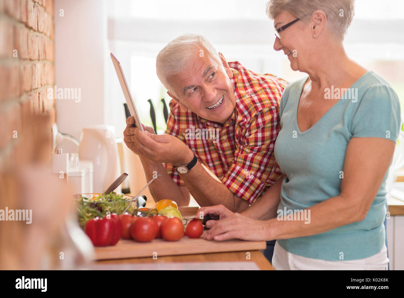 Helpful man and his wife preparing healthy meal Stock Photo - Alamy