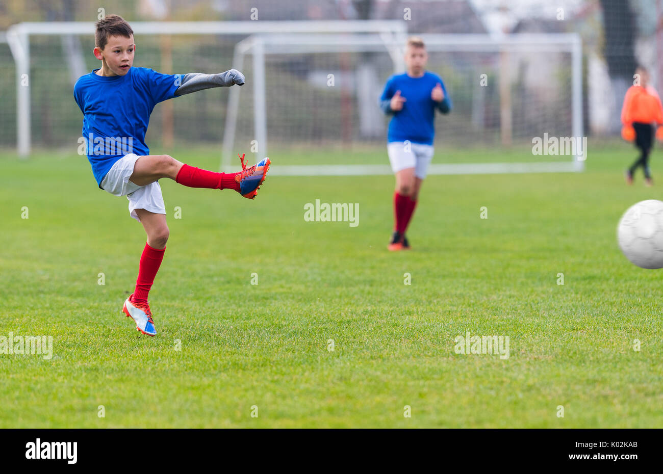 Boy kicking ball 9 hi-res stock photography and images - Alamy