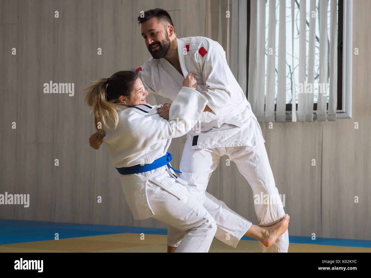 Young woman and man judo fighters in sport hall Stock Photo - Alamy