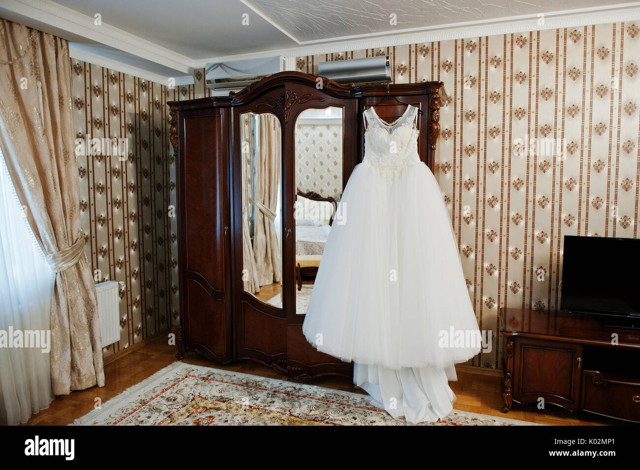 Wedding dress hanging on the rack on the wardrobe in the room Stock ...