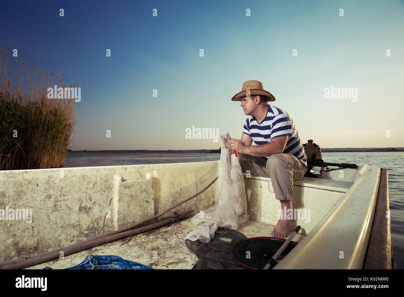 Fisherman fishing in the boat Stock Photo - Alamy