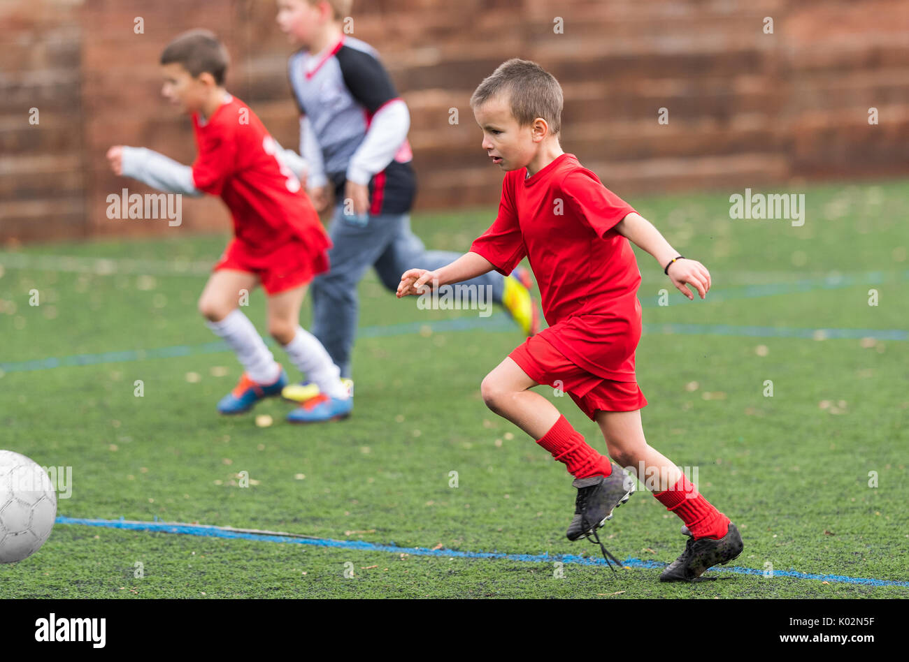 Boy kicking ball 9 hi-res stock photography and images - Alamy