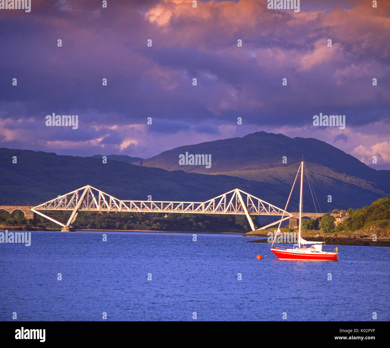 Evening light strikes Connel Bridge as the mouth of Loch Etive, Argyll ...