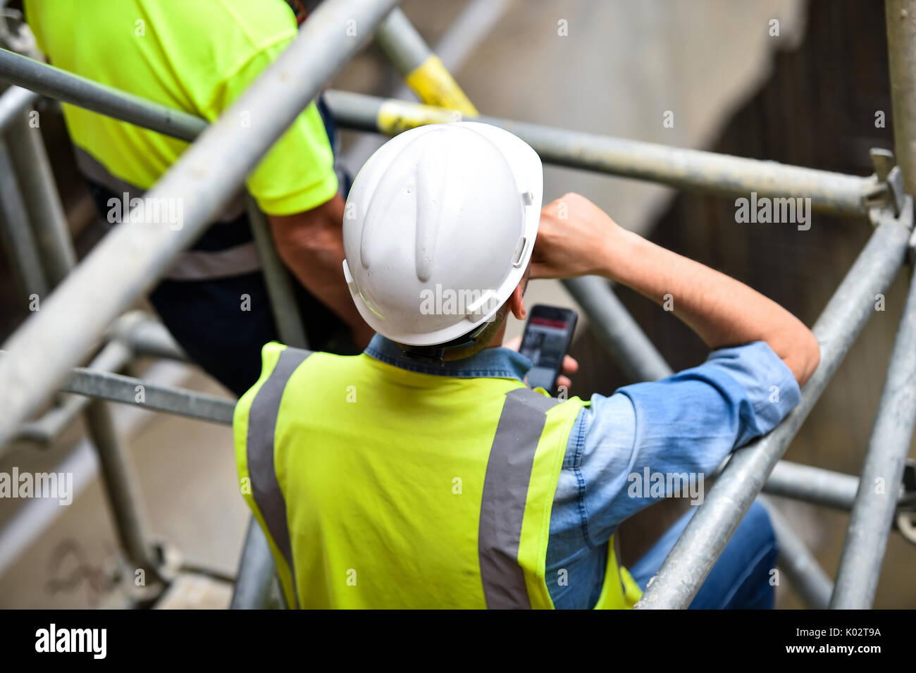 Workers inspecting construction works on a scaffold inside construction ...