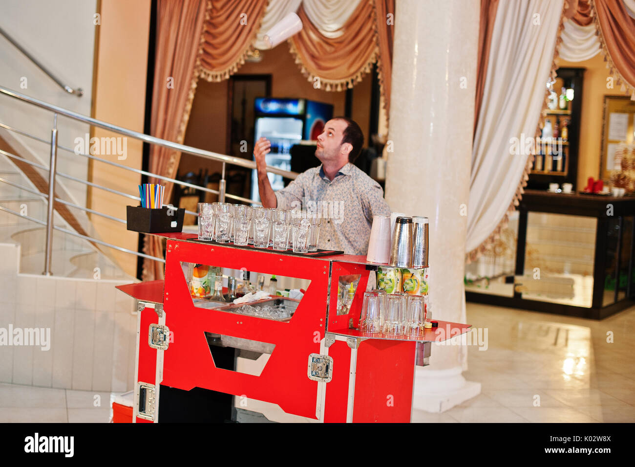 Skillful bartender performing bar tricks in front of a big audience on ...