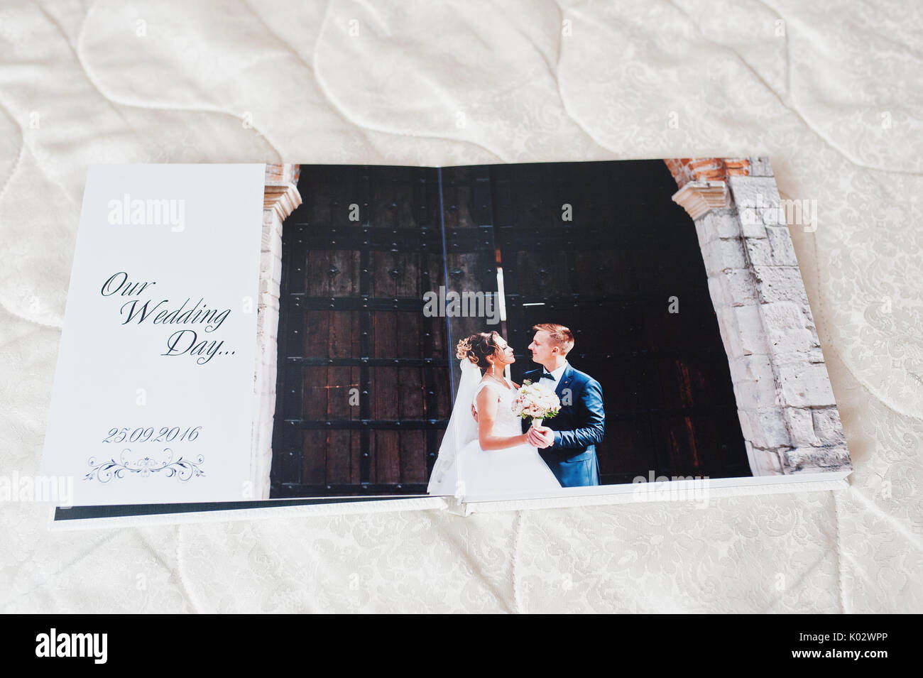 Pages of wedding photobook or wedding album on white sofa background ...