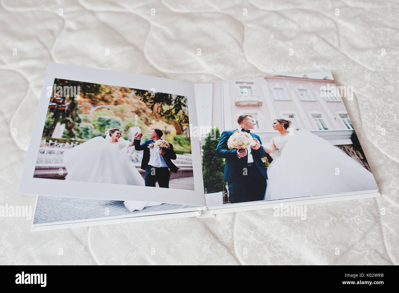 Pages of wedding photobook or wedding album on white sofa background ...