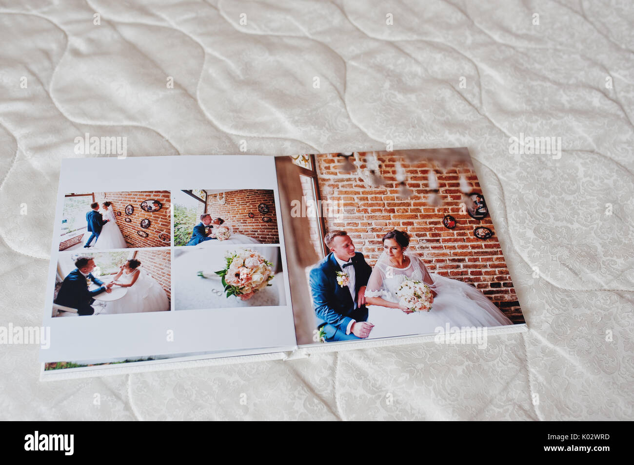 Pages of wedding photobook or wedding album on white sofa background ...