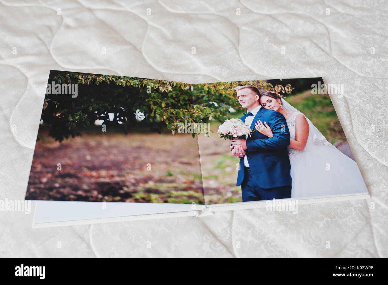 Pages of wedding photobook or wedding album on white sofa background ...